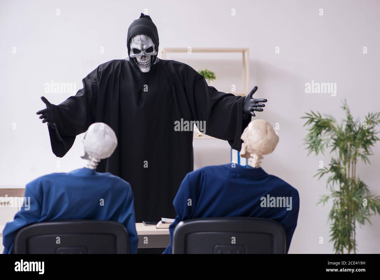 Funny business meeting with the devil and skeletons Stock Photo - Alamy