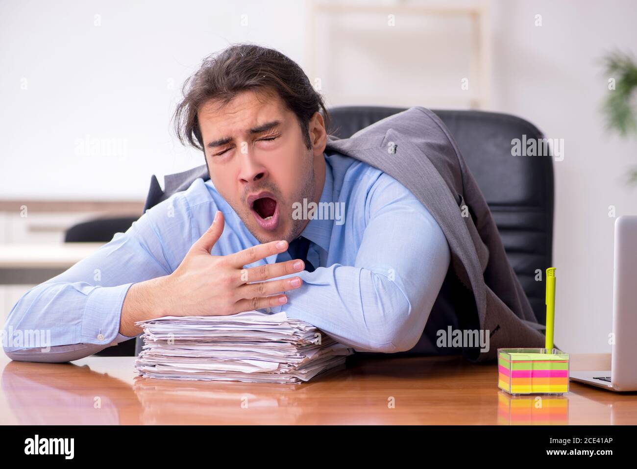 Young employee sleeping in the office Stock Photo - Alamy