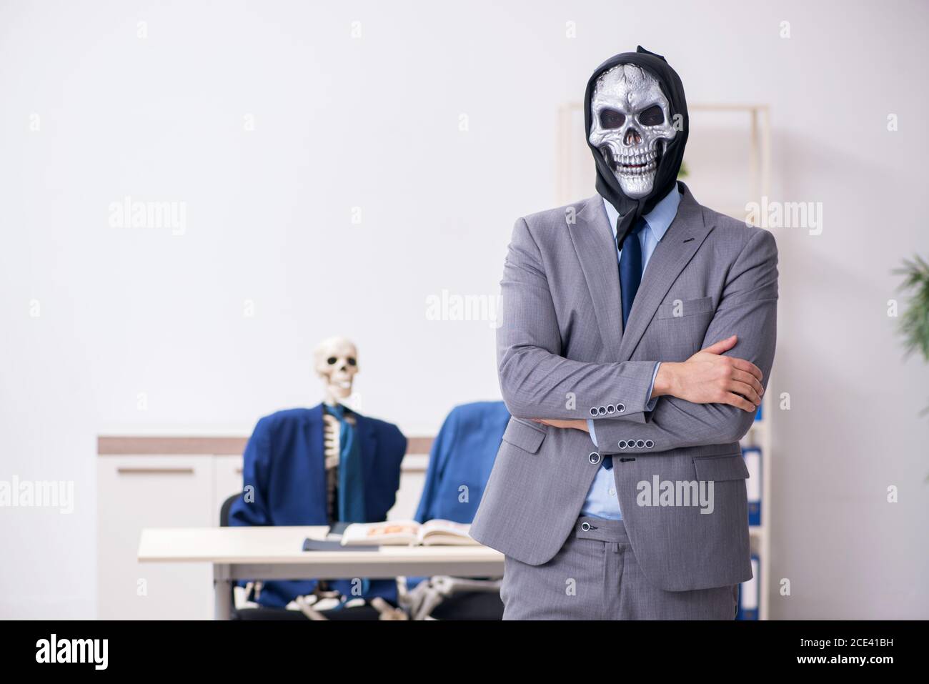 Funny business meeting with the devil and skeletons Stock Photo - Alamy