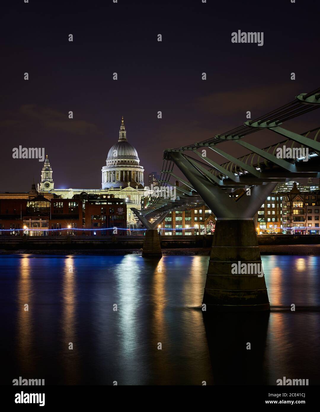 St. Paul's Cathedral and Millenium Bridge in London at night, in ...