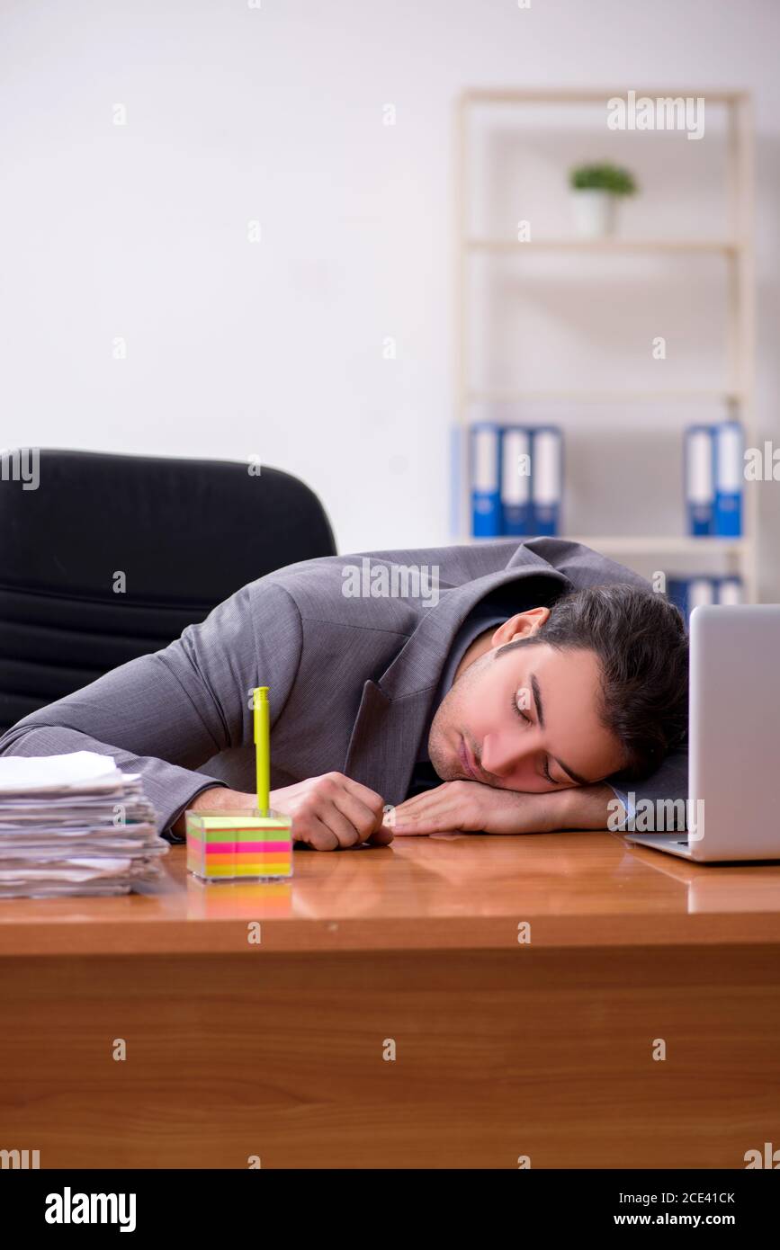 Young employee sleeping in the office Stock Photo - Alamy
