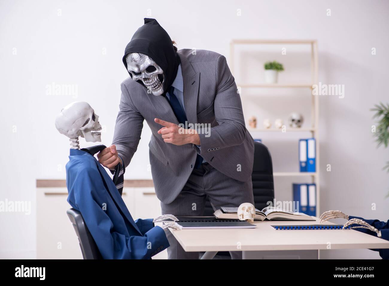 Funny business meeting with the devil and skeletons Stock Photo - Alamy