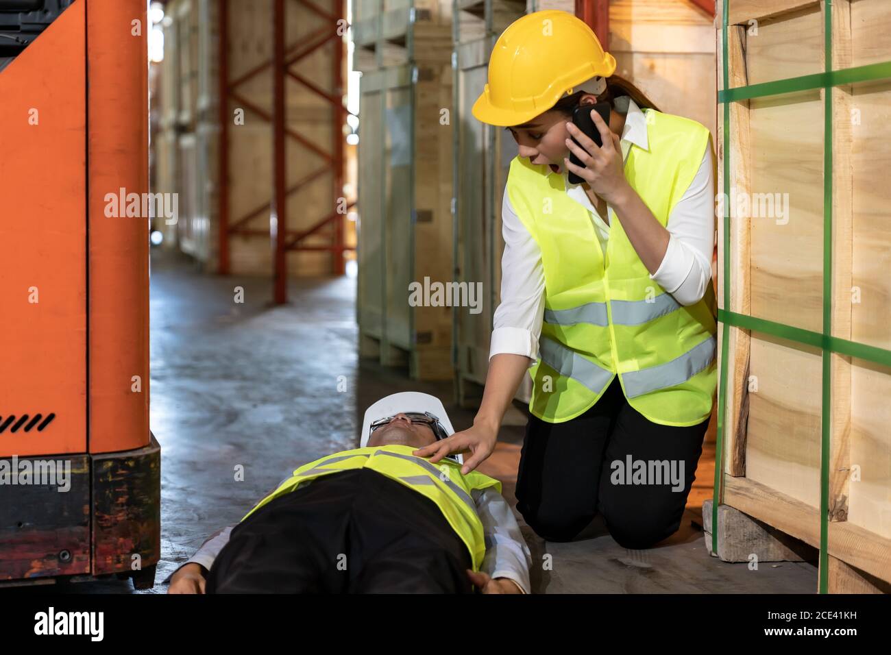 Warehouse worker call ambulance after accident Stock Photo - Alamy