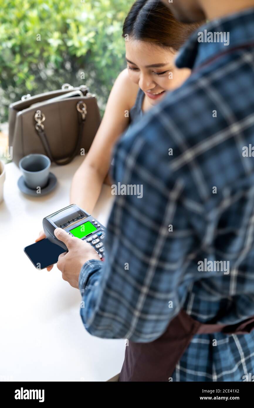 Asian customer make payment with contactless mobile phone Stock Photo ...