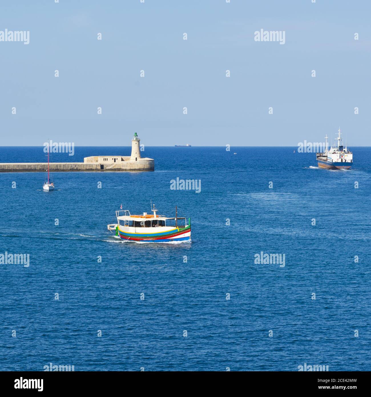 Cargo ship and pleasure craft Stock Photo - Alamy
