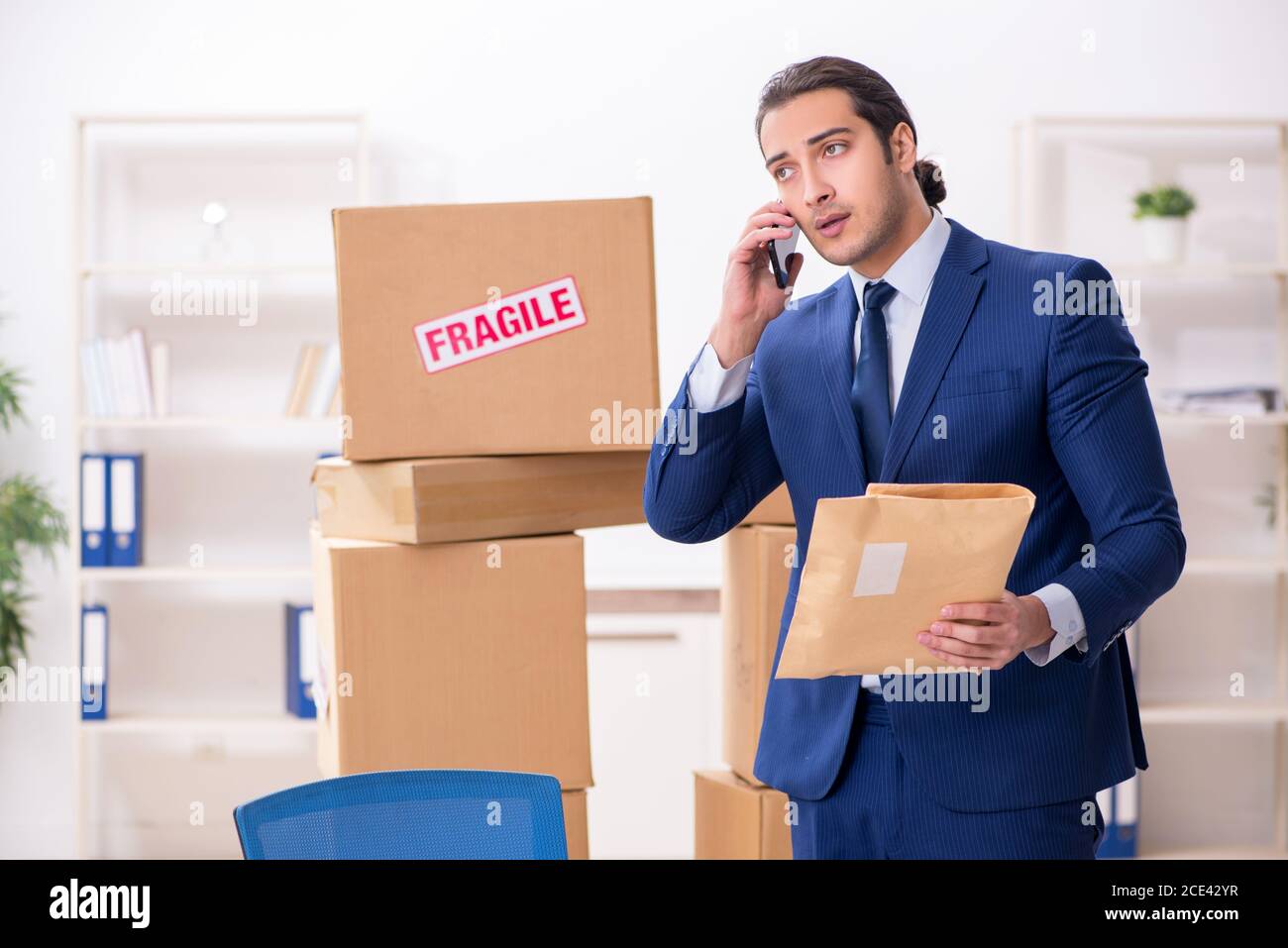 Young logistics specialist working in the office Stock Photo - Alamy