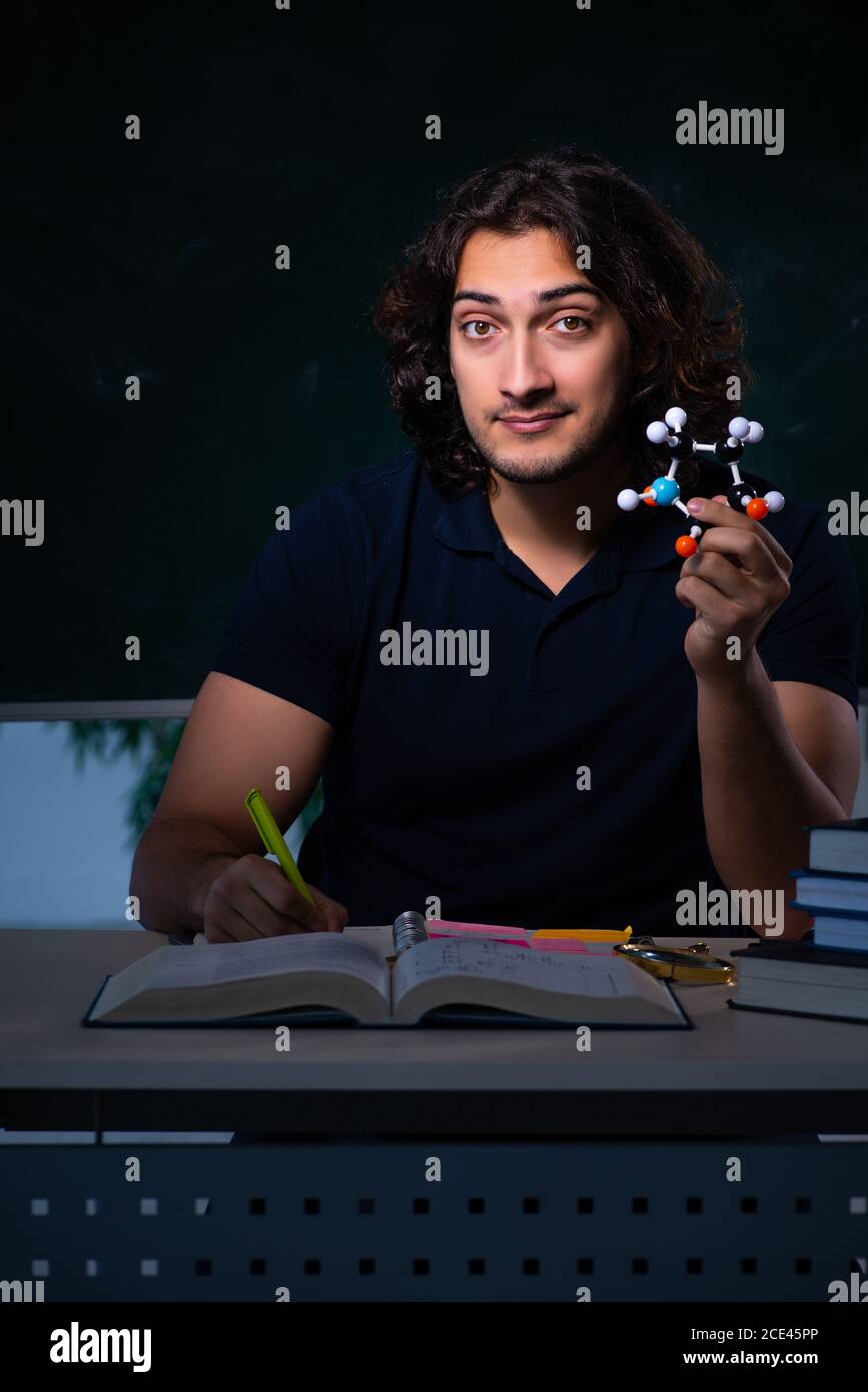 Young student in the classroom at night Stock Photo - Alamy