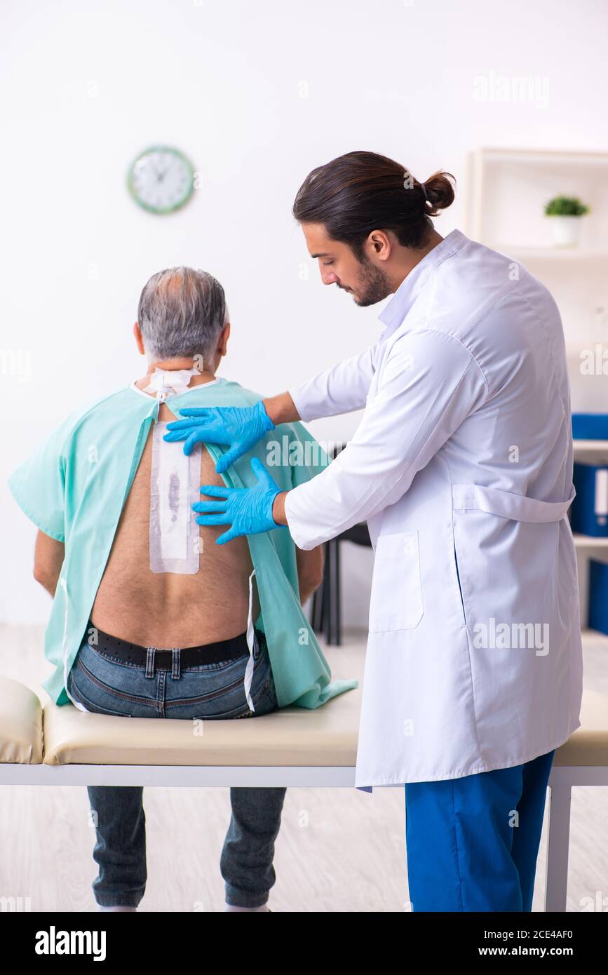 Old man visiting male doctor Stock Photo - Alamy