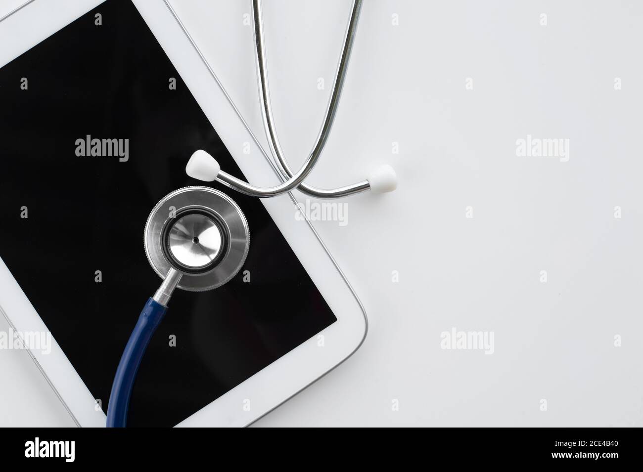 blue stethoscope with white tablet for doctor health diagnosis in ...