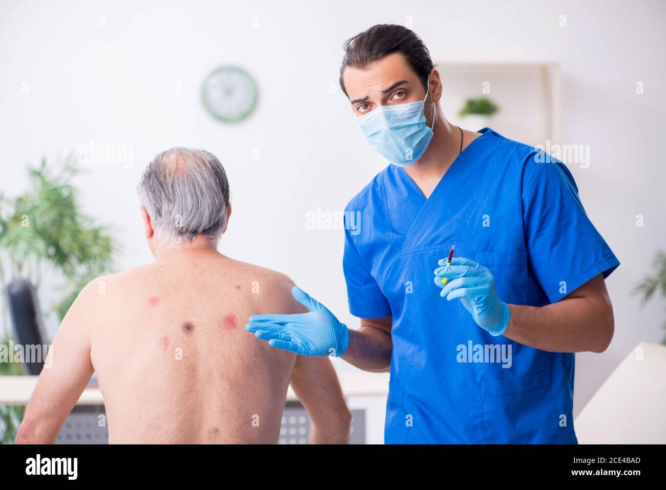 Old man visiting male doctor dermatologist Stock Photo - Alamy
