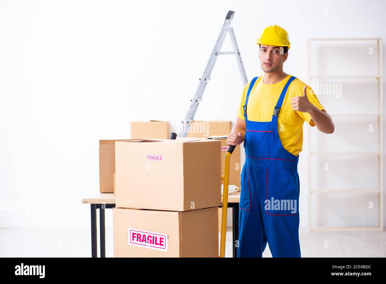 Young professional mover doing home relocation Stock Photo - Alamy