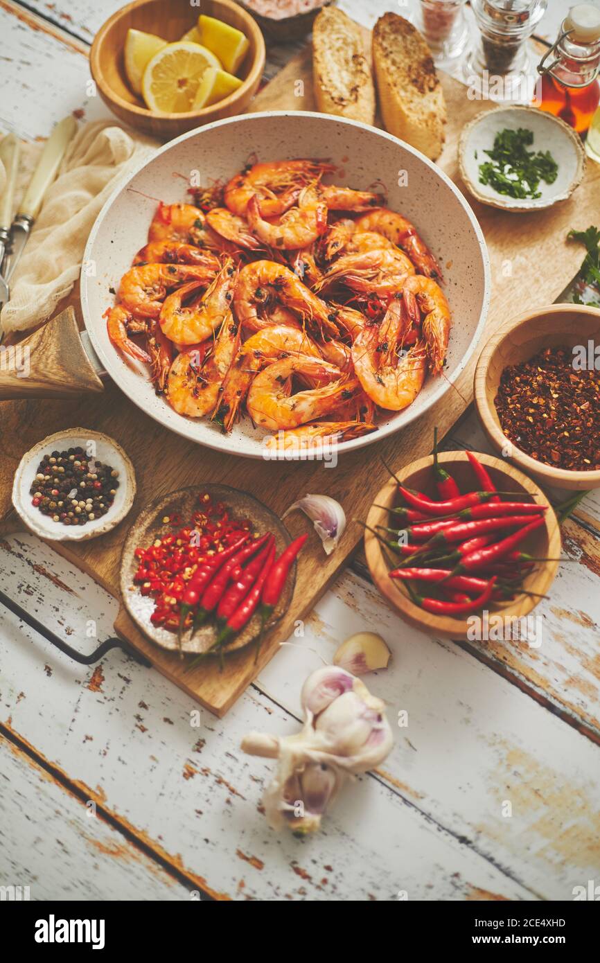Traditional fried tiger prawn with garlic bread as top view served in a ...