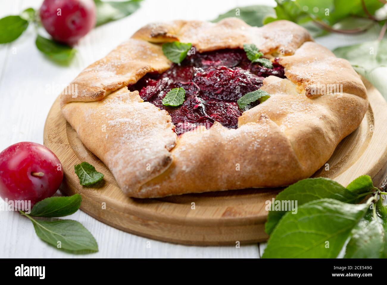 Traditional open pie with red plums Stock Photo - Alamy