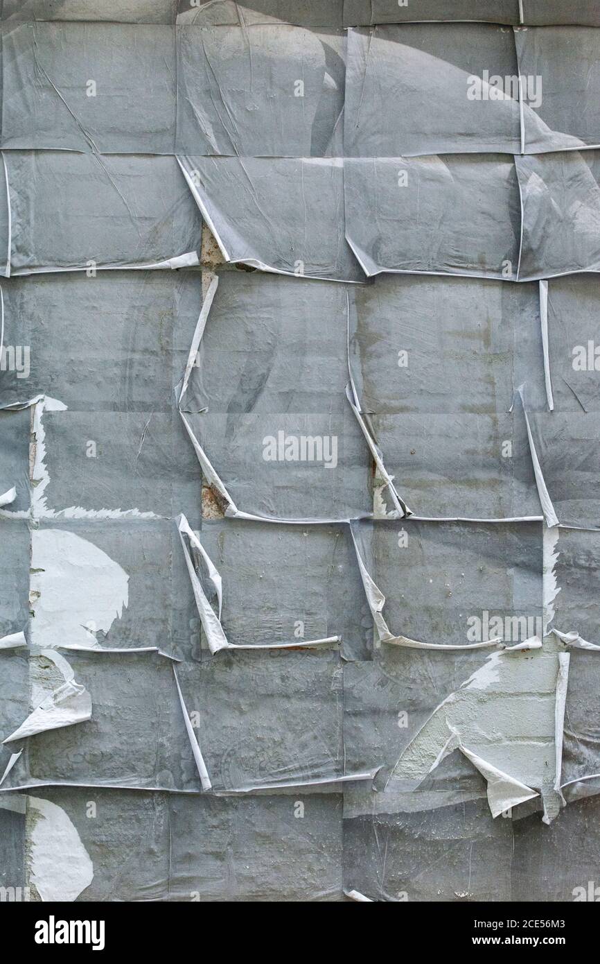 street wallpaper made of gray peeled paper sheets Stock Photo - Alamy