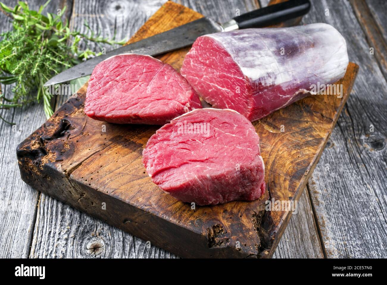 Dry aged beef fillet steak natural as closeup with spice and salt on a ...
