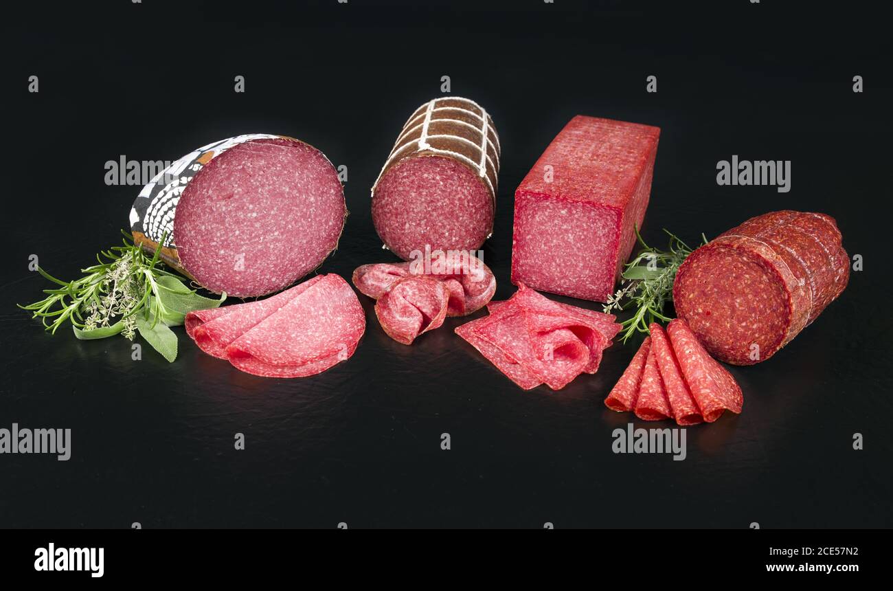 Traditional Salami as closeup offered on a black board with copy space ...