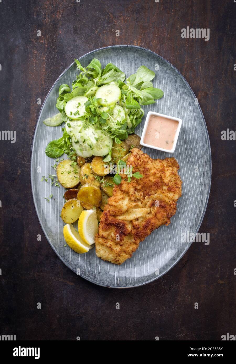 Fried Wiener schnitzel from veal topside with fried potatoes and ...