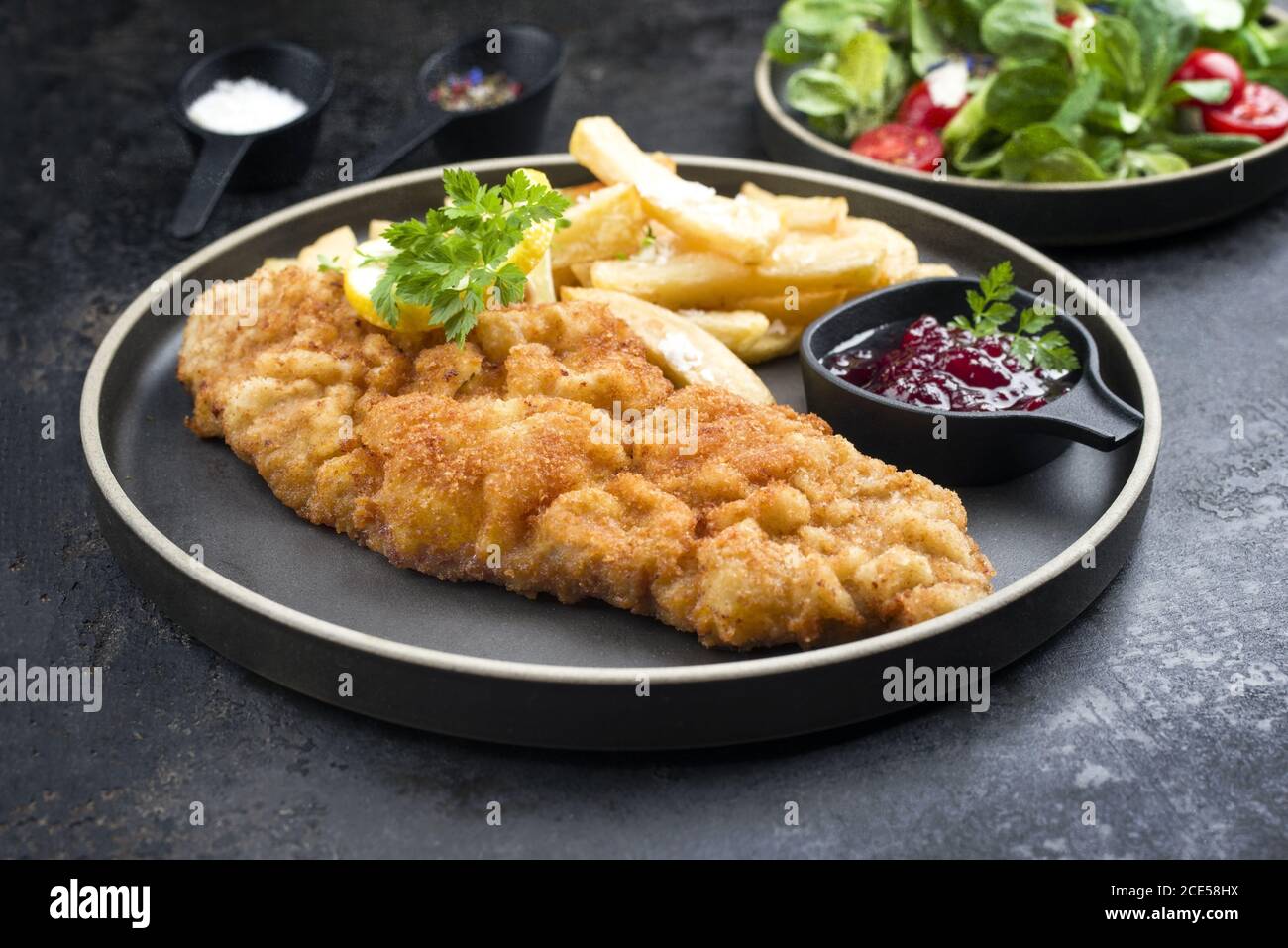 Fried Wiener schnitzel from veal topside with French fries and lettuce ...