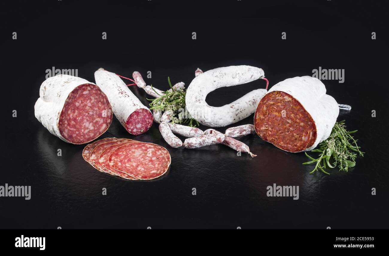 Traditional Salami as closeup offered on a black board with copy space ...