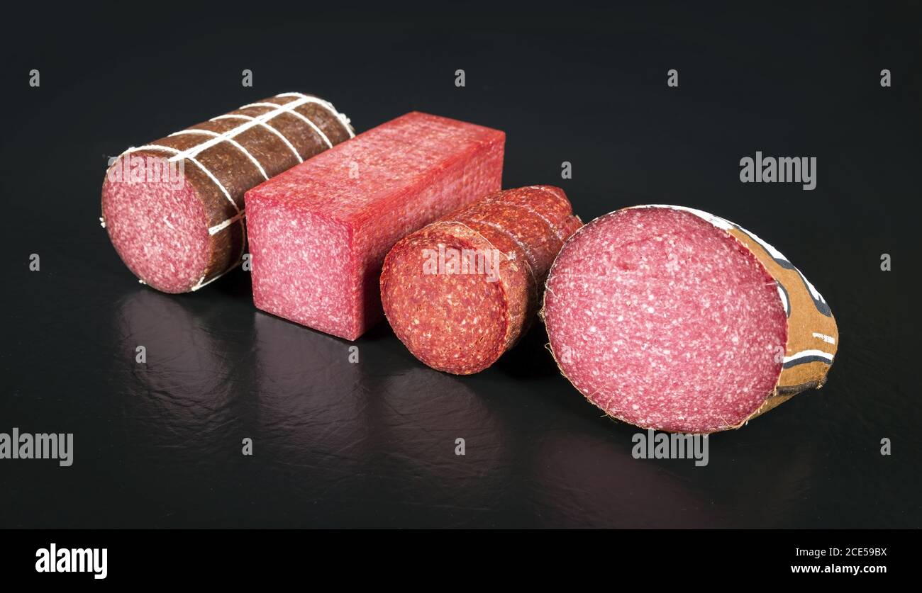 Traditional Salami as closeup offered on a black board with copy Stock ...