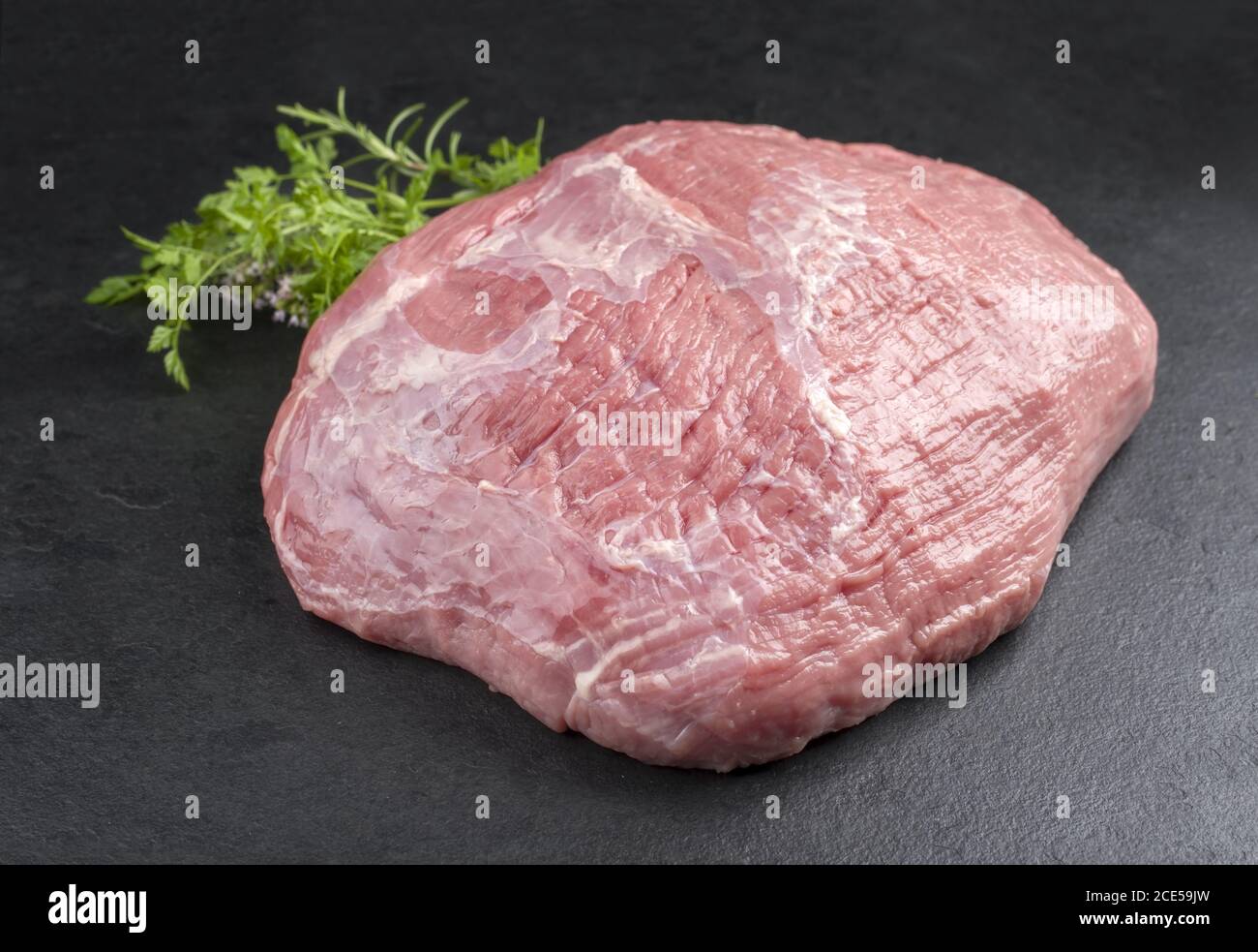 Raw veal topside as closeup on black background with copy space Stock ...