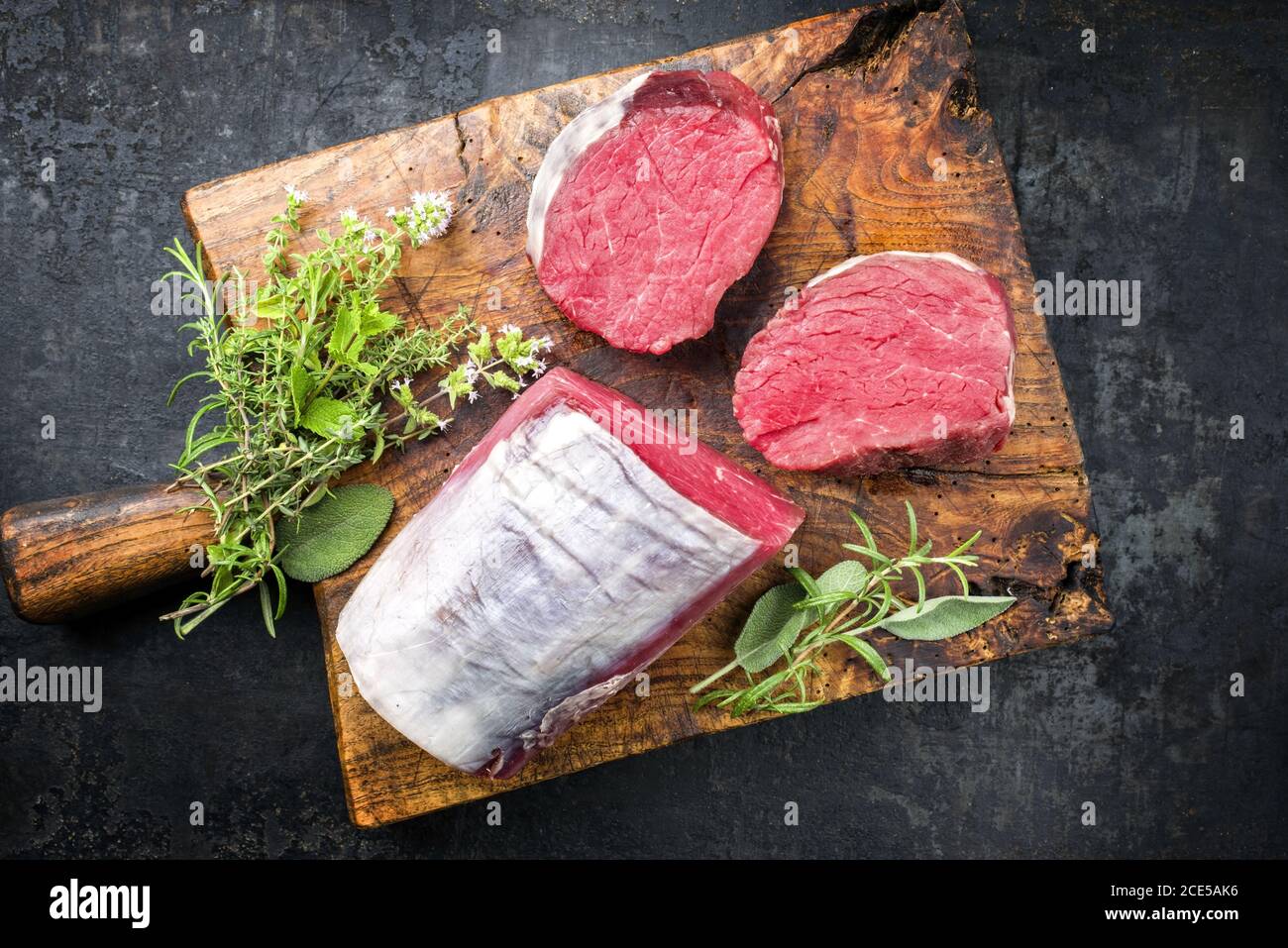 Dry aged beef fillet medallion steak natural as top view on a wooden ...