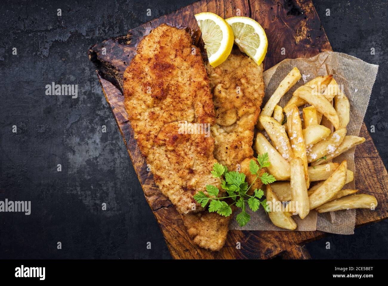 Fried Wiener schnitzel from veal topside with French fries and lemon ...