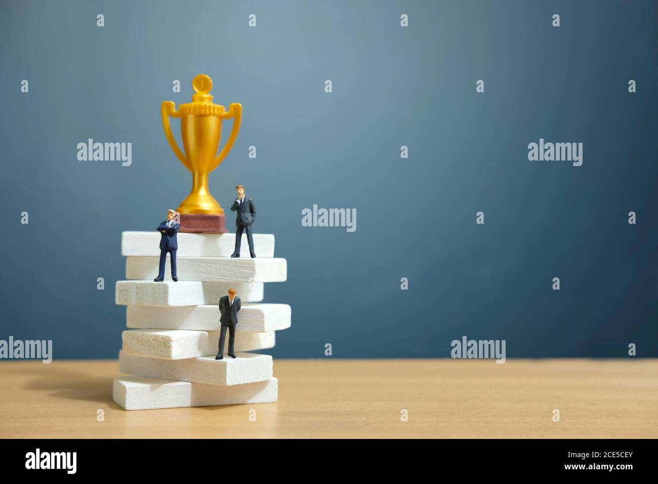 Miniature business concept - businessman standing on white staircase ...