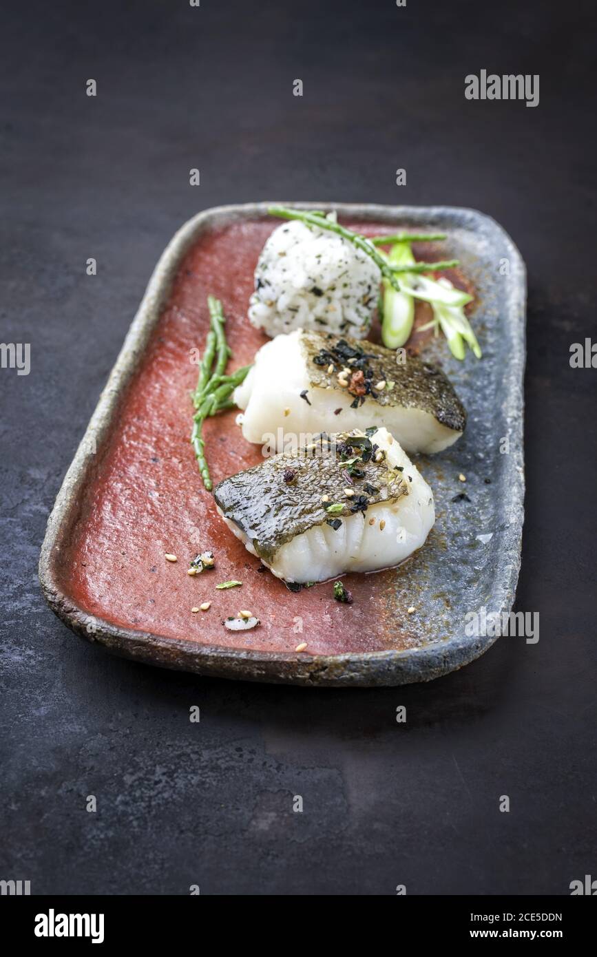 Gourmet fried Japanese skrei cod fish filet with glasswort and furikake ...