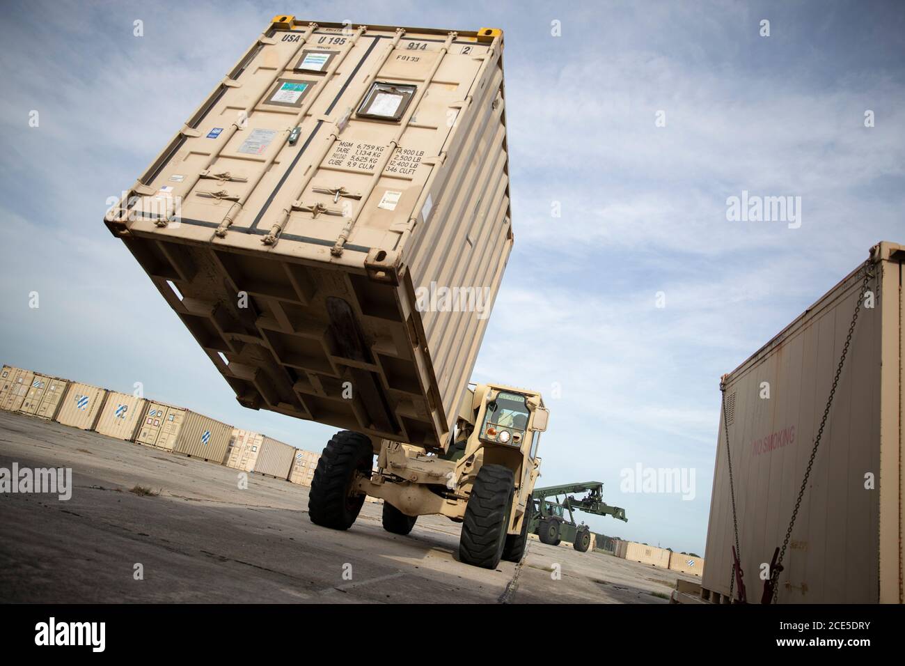 Soldiers assigned to the 3rd Infantry Division move and sort containers ...