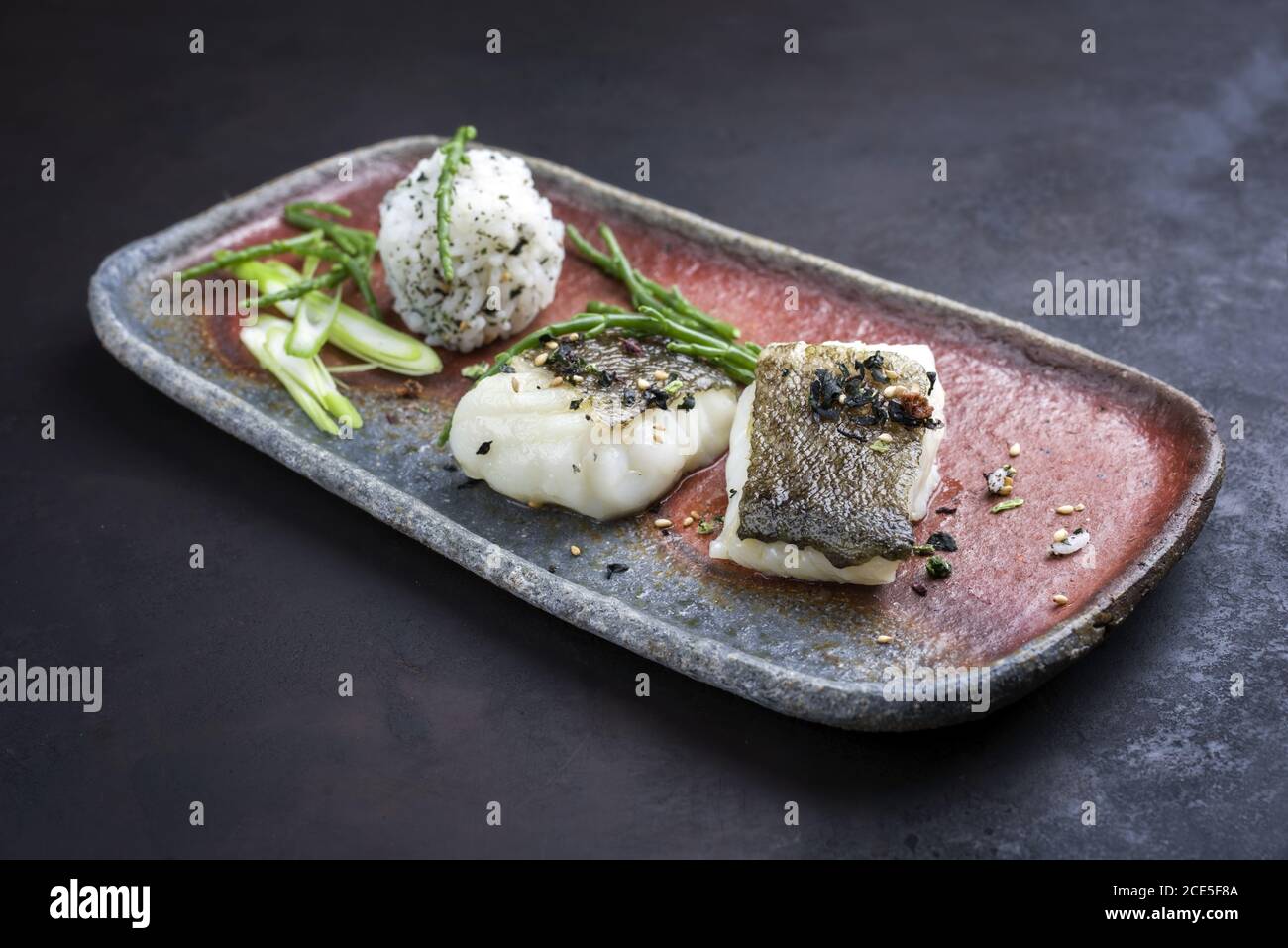 Gourmet fried Japanese skrei cod fish filet with glasswort and furikake ...