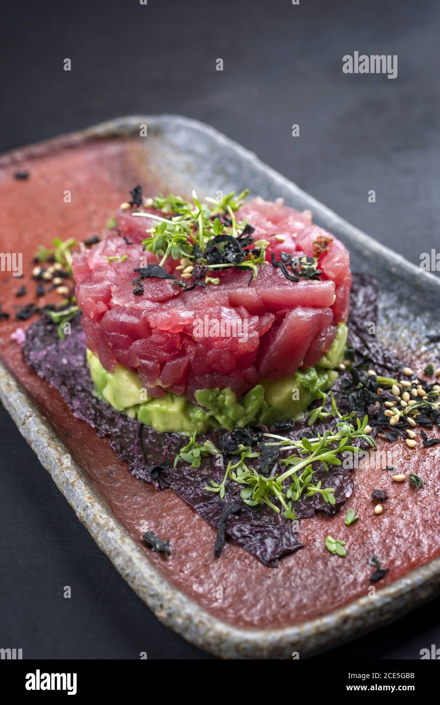 Gourmet fish tartar raw from tuna fillet with hashed avocado Stock ...