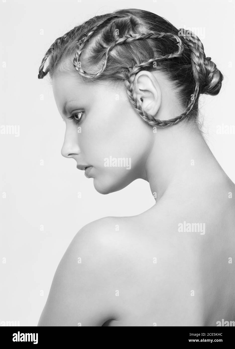Black and white portrait in high key tone female with creative hairdo ...