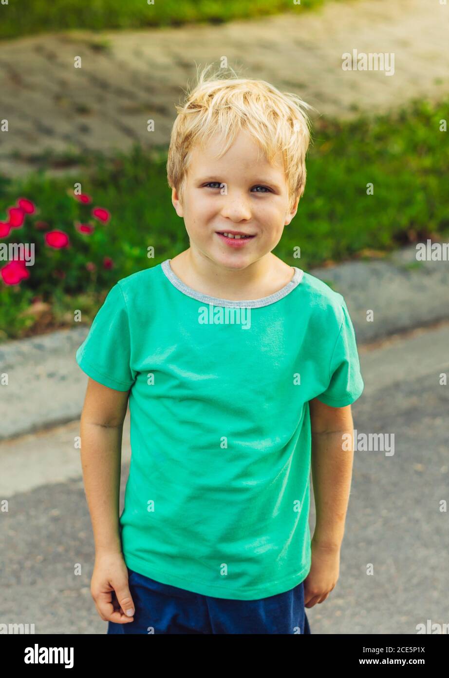 Happy Mischievous Cheerful Cute Blond Boy With Freckles Face Playing Outside Laughing happy-mischievous-cheerful-cute-blond-boy-with-freckles-face-playing-outside-laughing