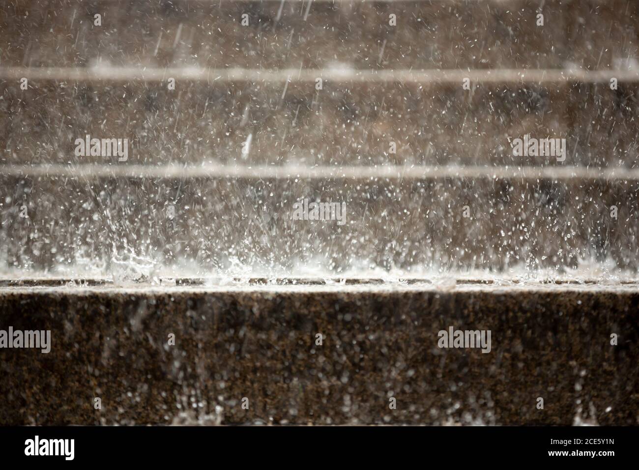 Heavy rain droplets are seen falling on concrete stairs Stock Photo - Alamy