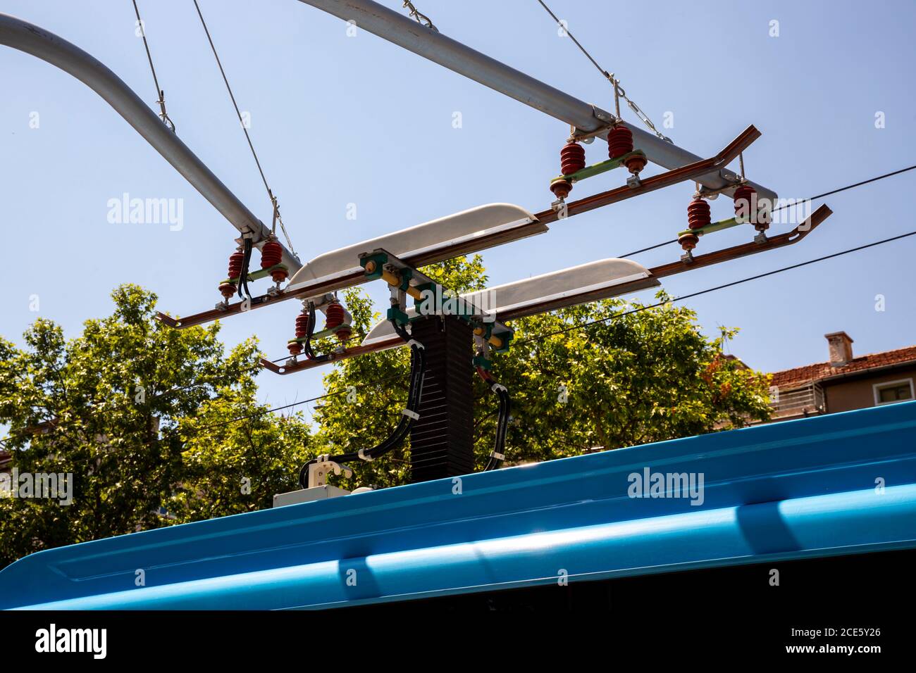 Electric bus electric overhead lines on a bus station during a recharge ...