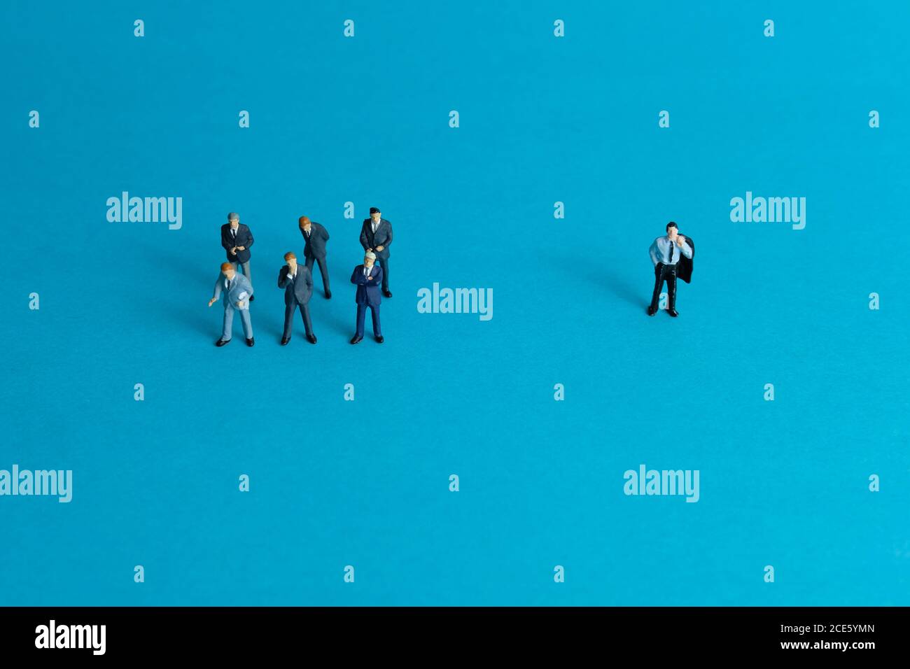 businessman miniature people concept - inequality in office workplace ...