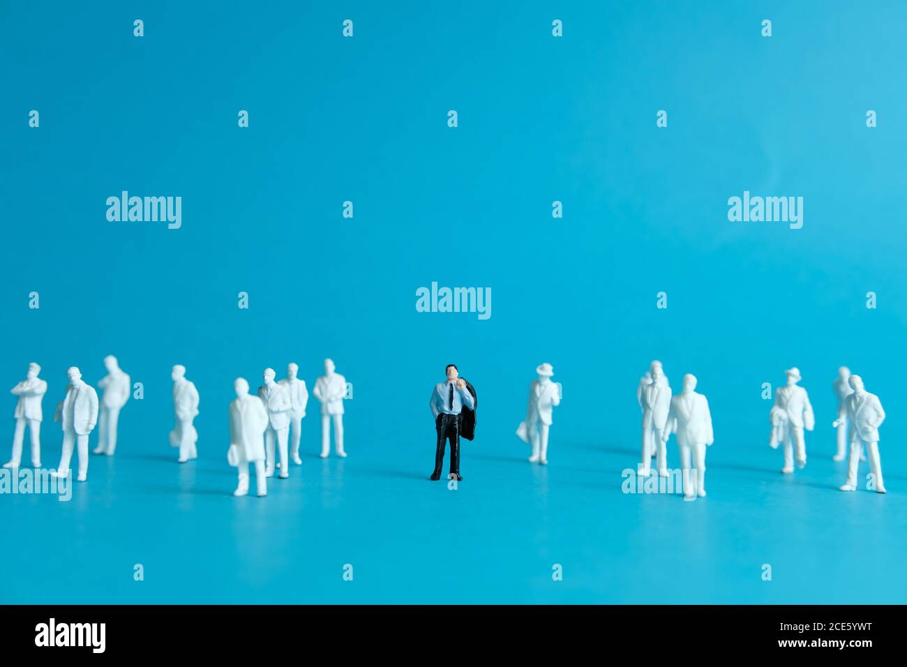 Miniature people concept - a different business worker standout from ...