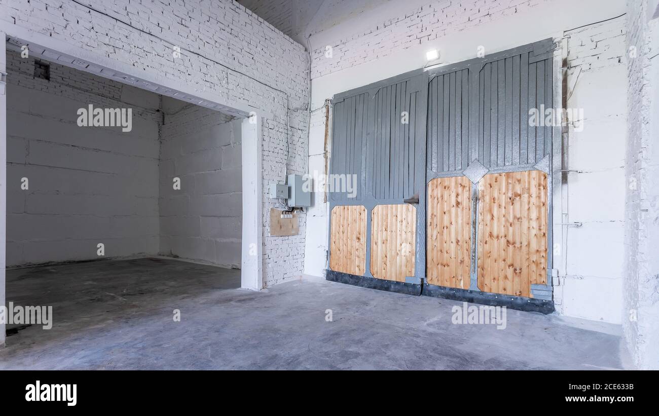 Industrial building interior with white brick walls, concrete floor ...