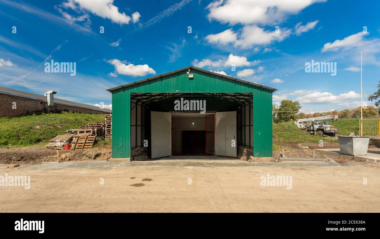 Green warehouse with sheet metal cladding with street lights ...