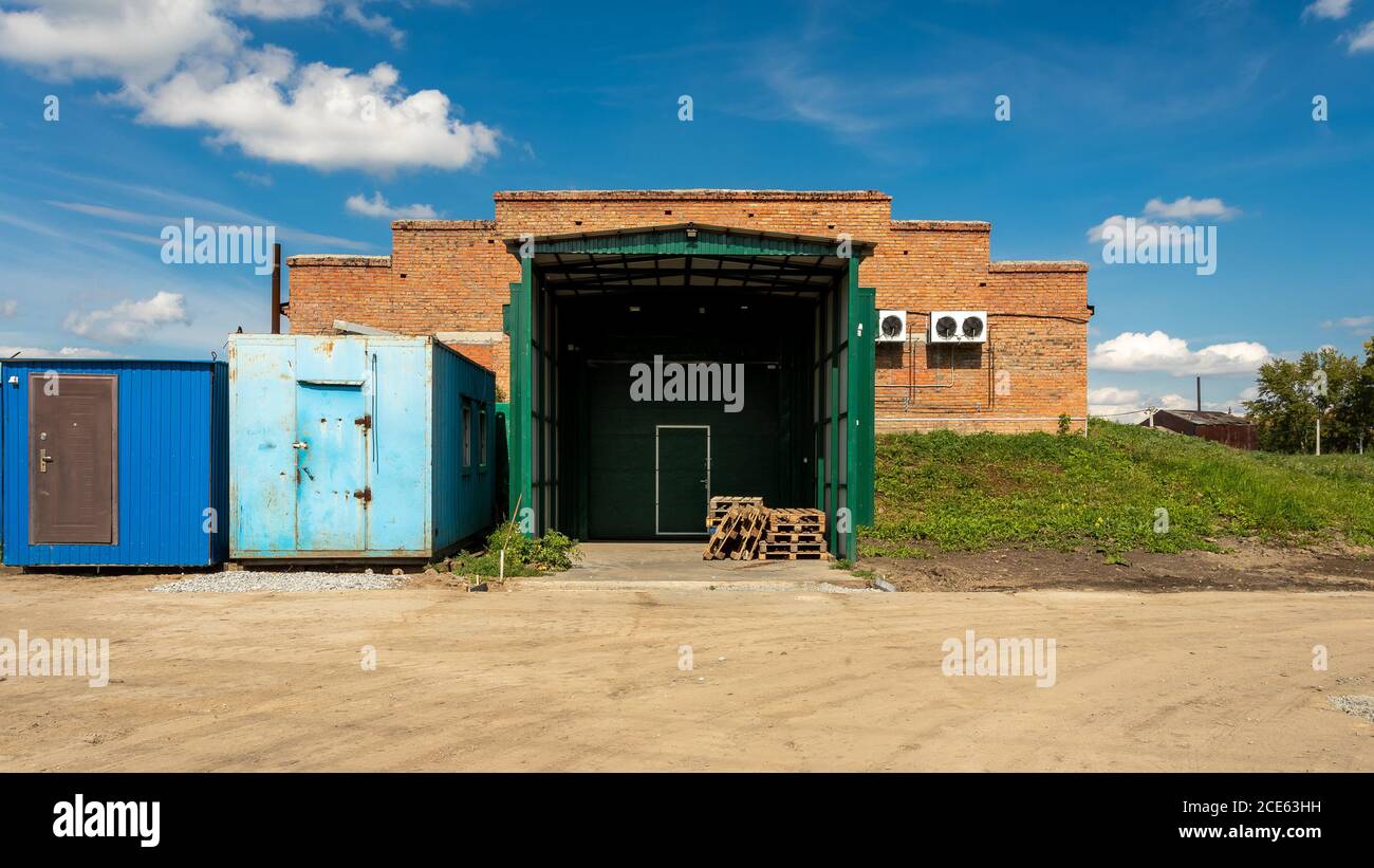 Facade of a metal and brick warehouse, commercial building for storage ...