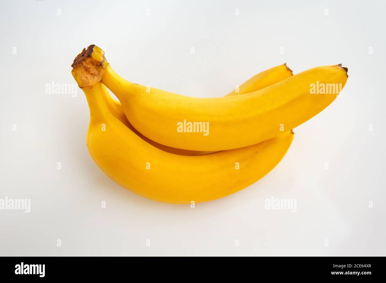 Branch of ripe bananas on a white background Stock Photo - Alamy