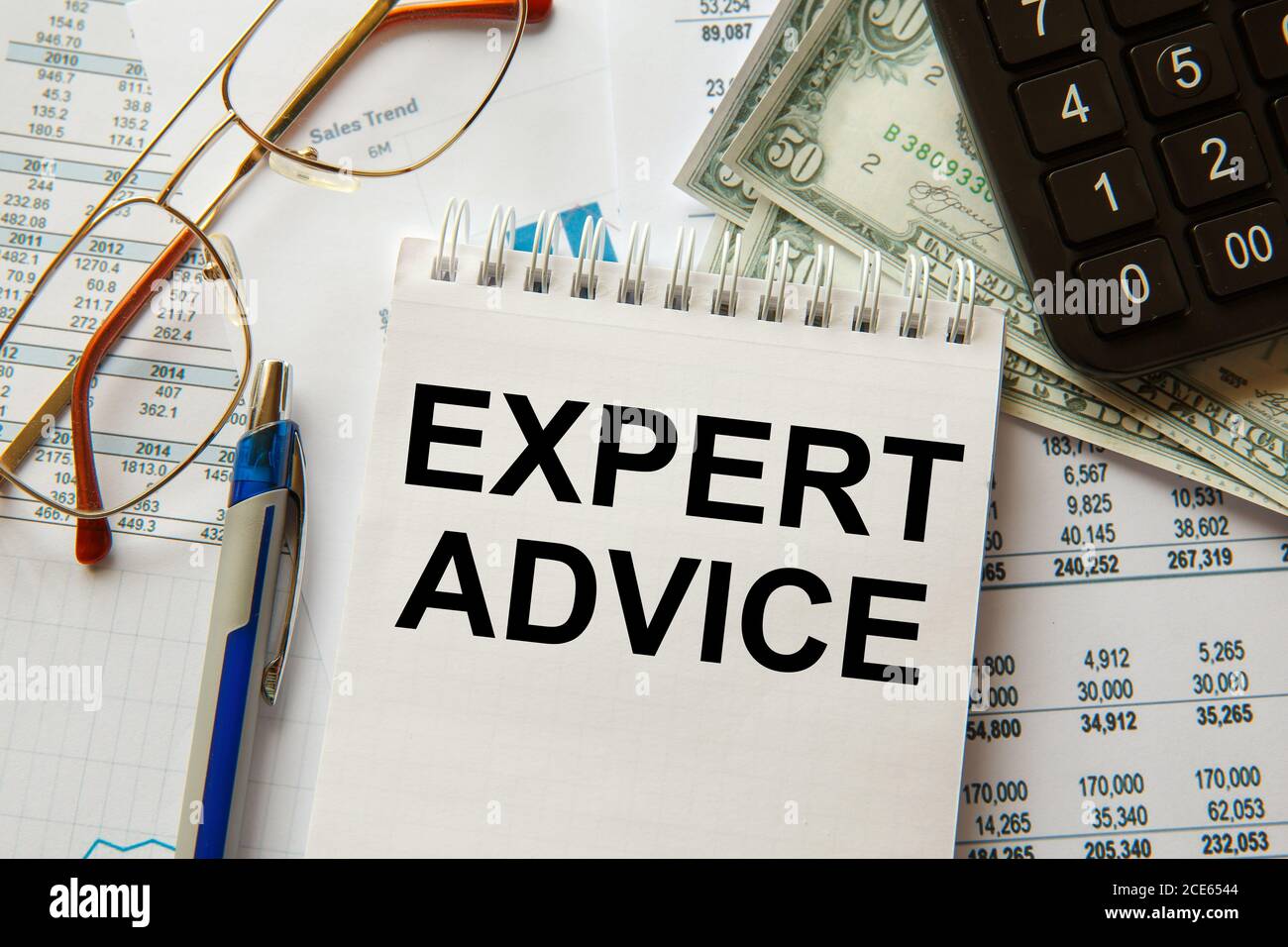EXPERT ADVICE is written on a notepad, on an office desk with office ...