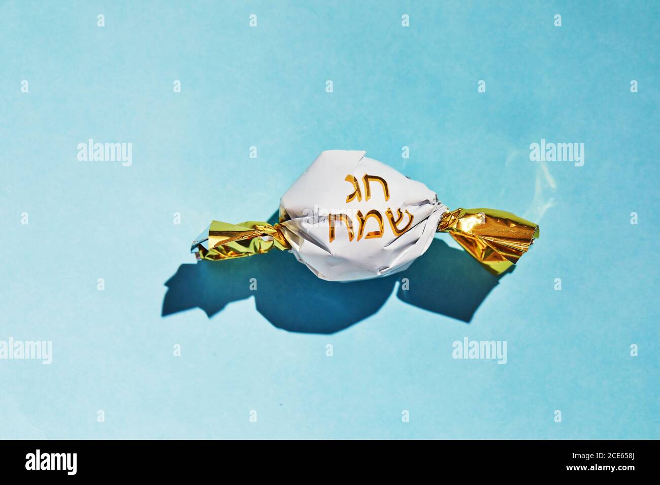 Candy cane with the inscription in Hebrew - Happy holiday. The concept ...