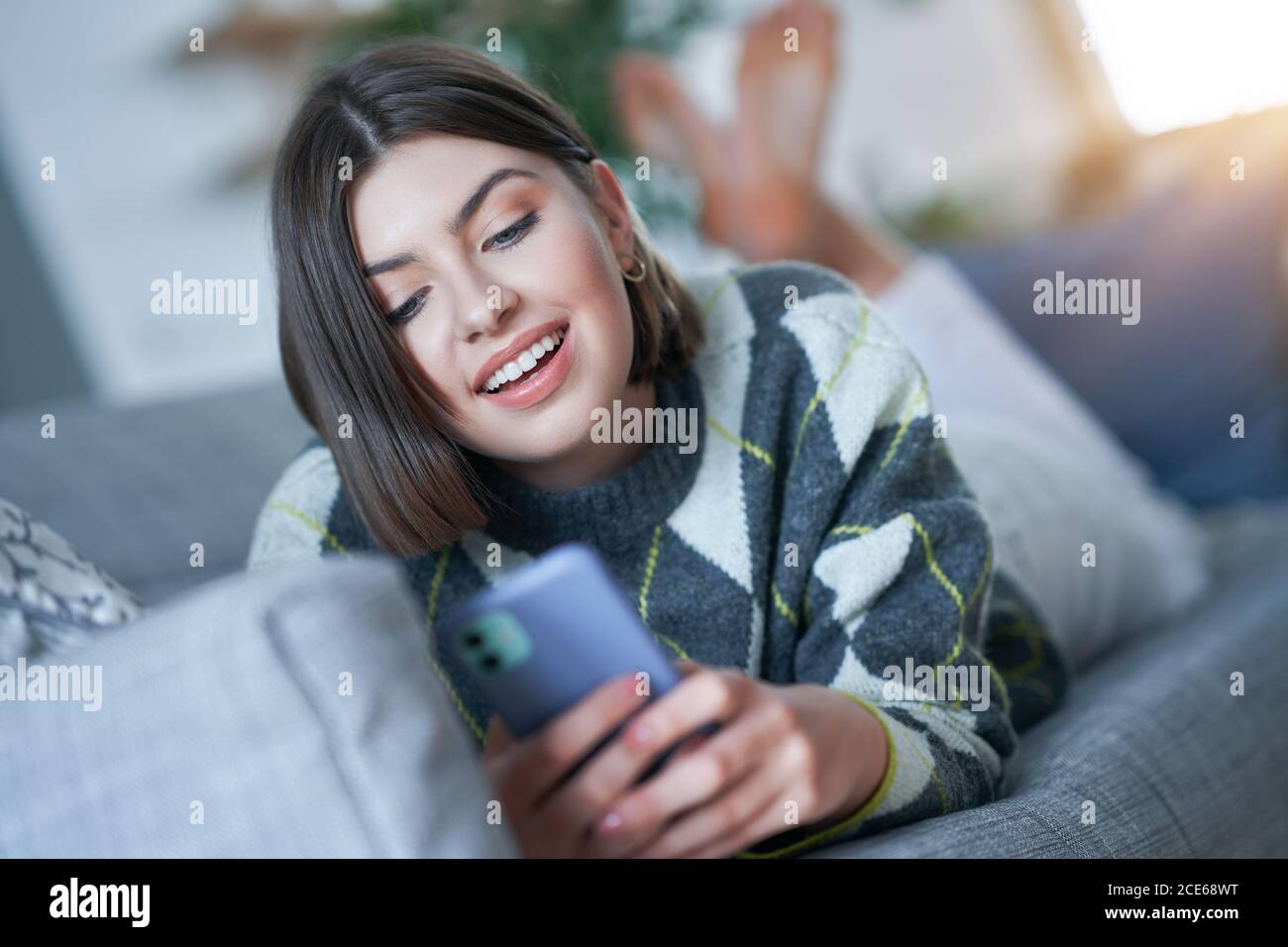 Teenage girl texting at home Stock Photo - Alamy