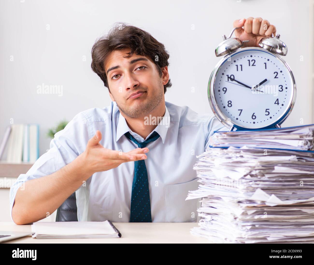 The overloaded busy employee with too much work and paperwork Stock ...