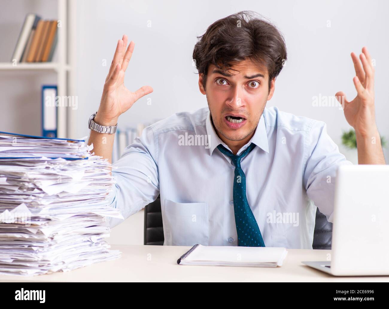 The overloaded busy employee with too much work and paperwork Stock ...