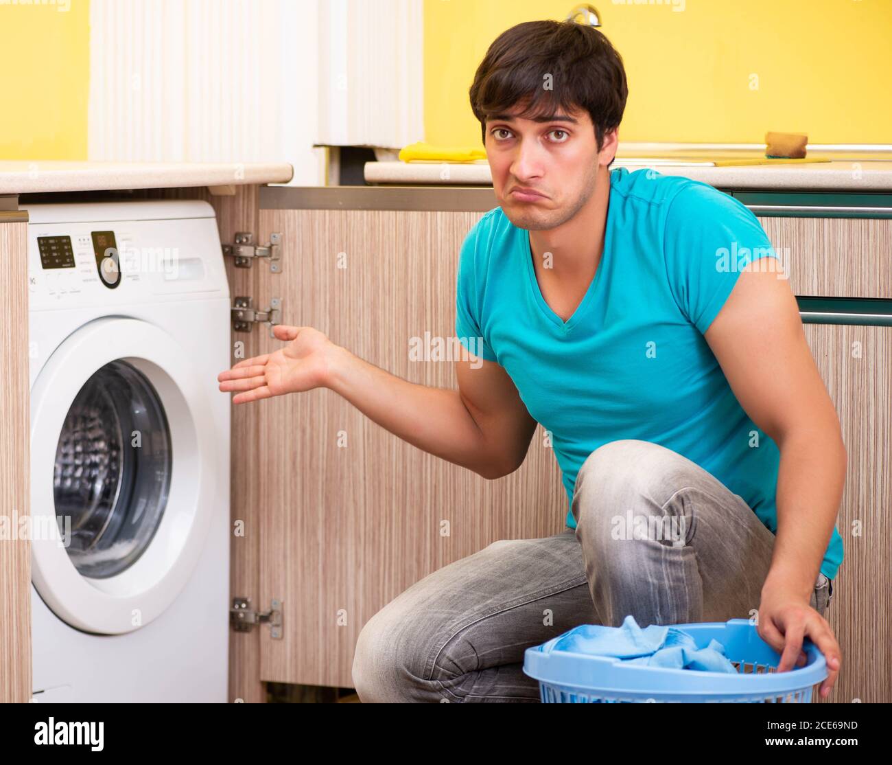 The young husband man doing laundry at home Stock Photo - Alamy