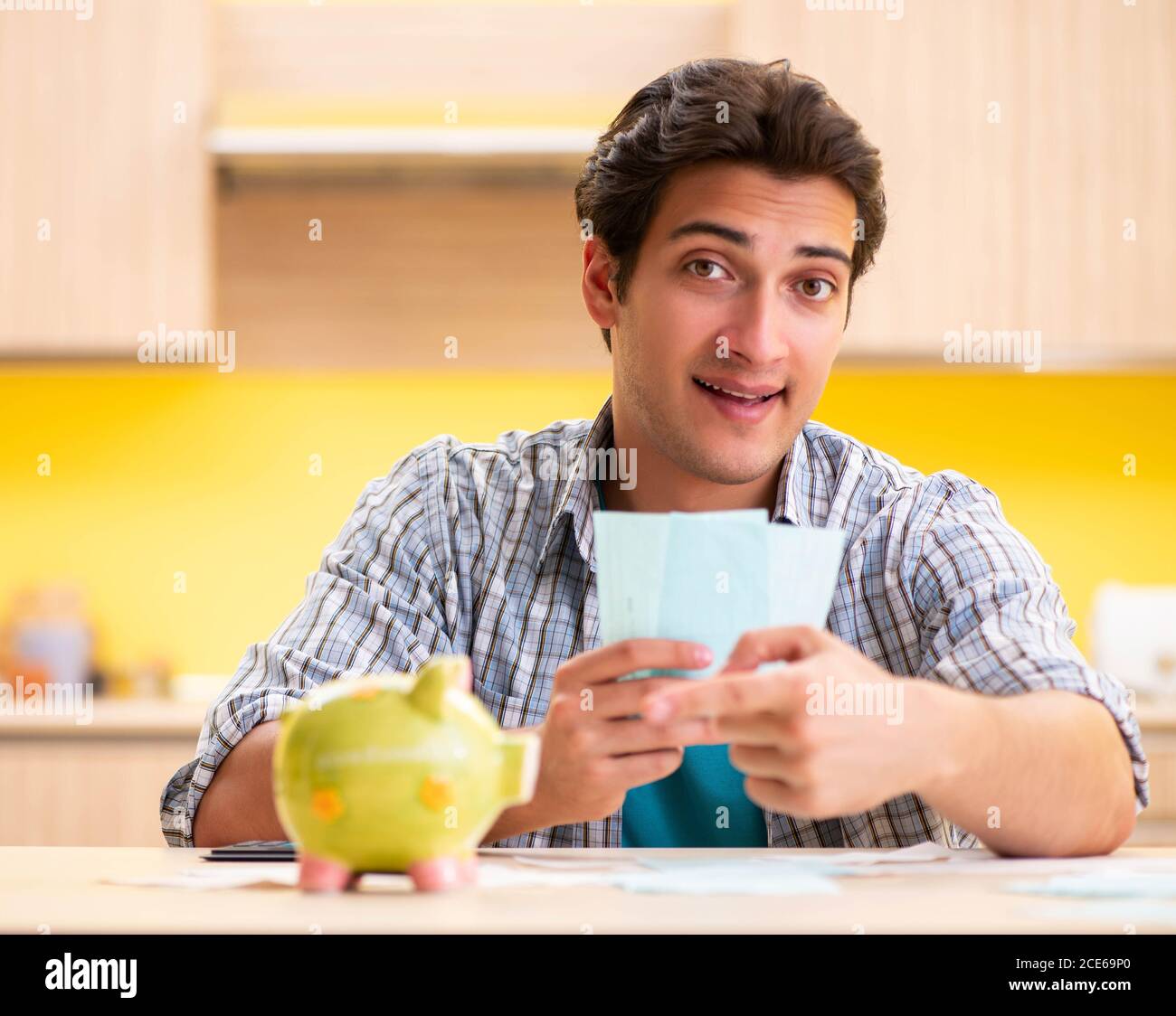 The young man husband in budget planning concept Stock Photo - Alamy
