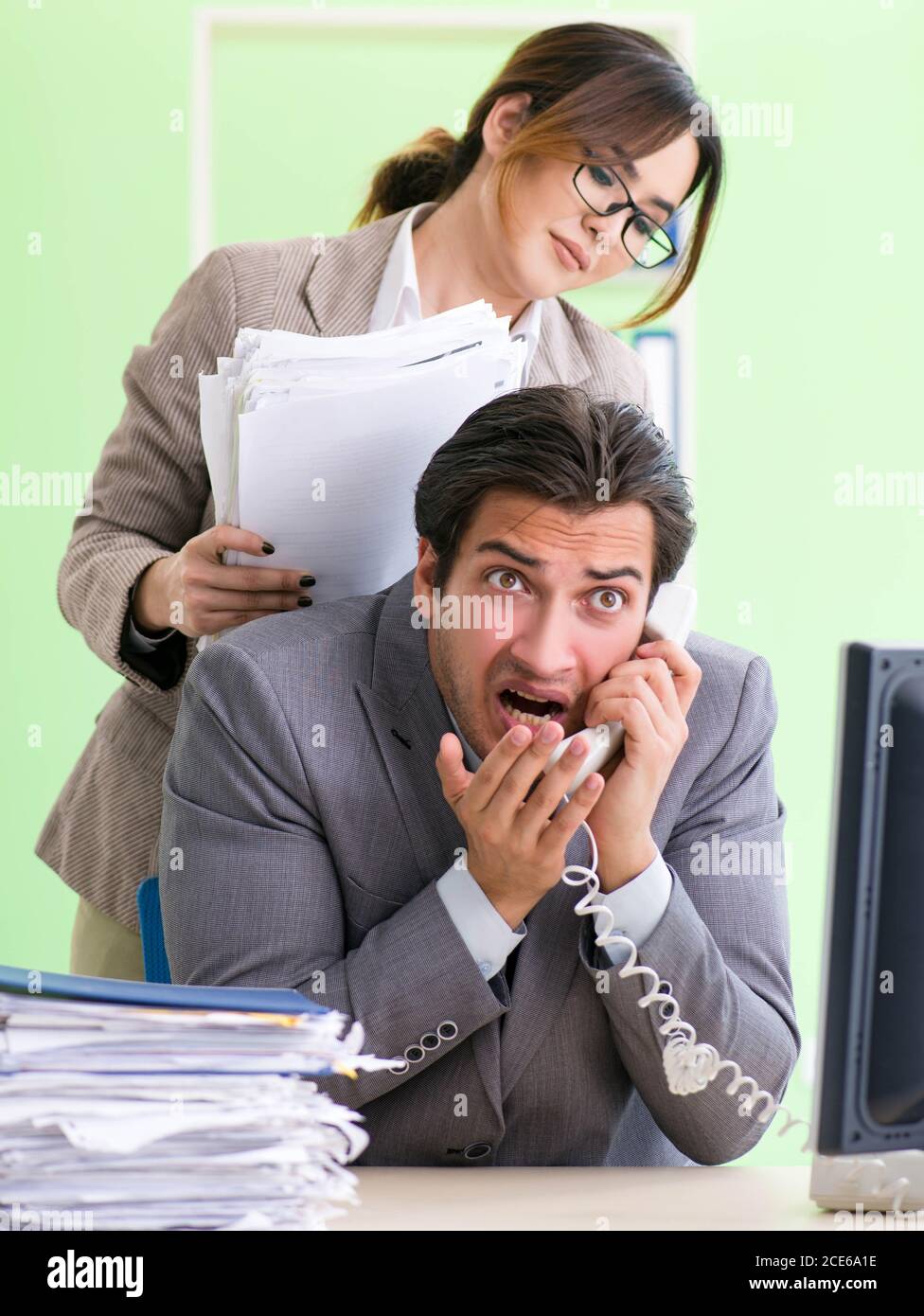 The man employee suffering from excessive work Stock Photo - Alamy